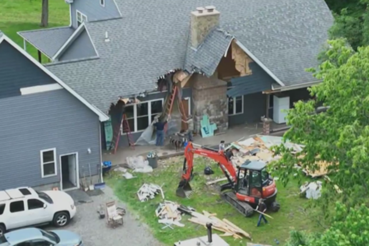 Man used excavator to smash his home with wife and kids inside: cops