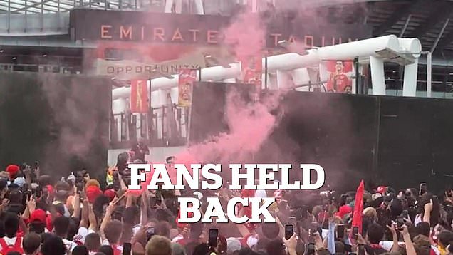 Arsenal fans try to force their way into Emirates Stadium