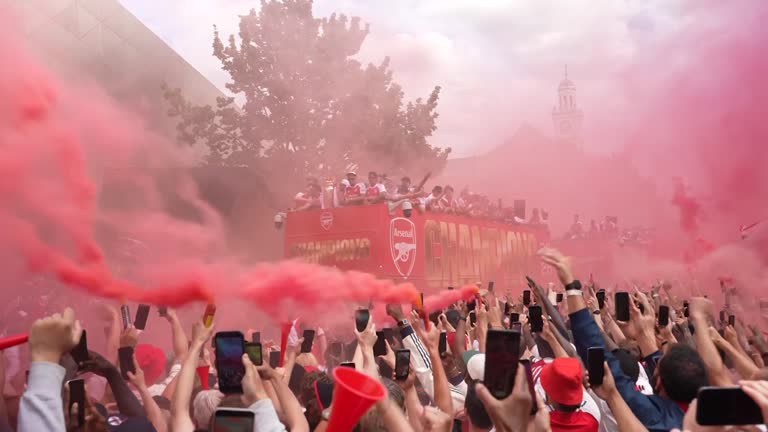 Arsenal fans celebrate Premier League win with open-top bus parade