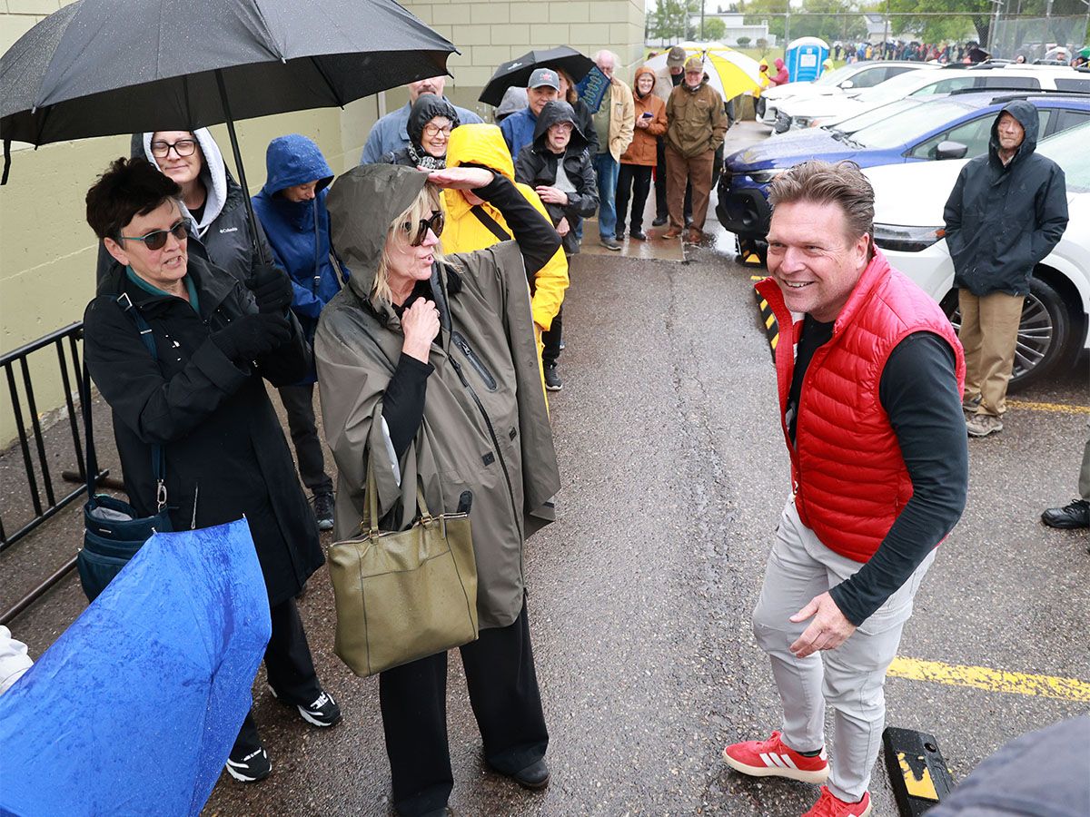 Hundreds of Calgarians brave pouring rain for Forever Canadian lawn ...