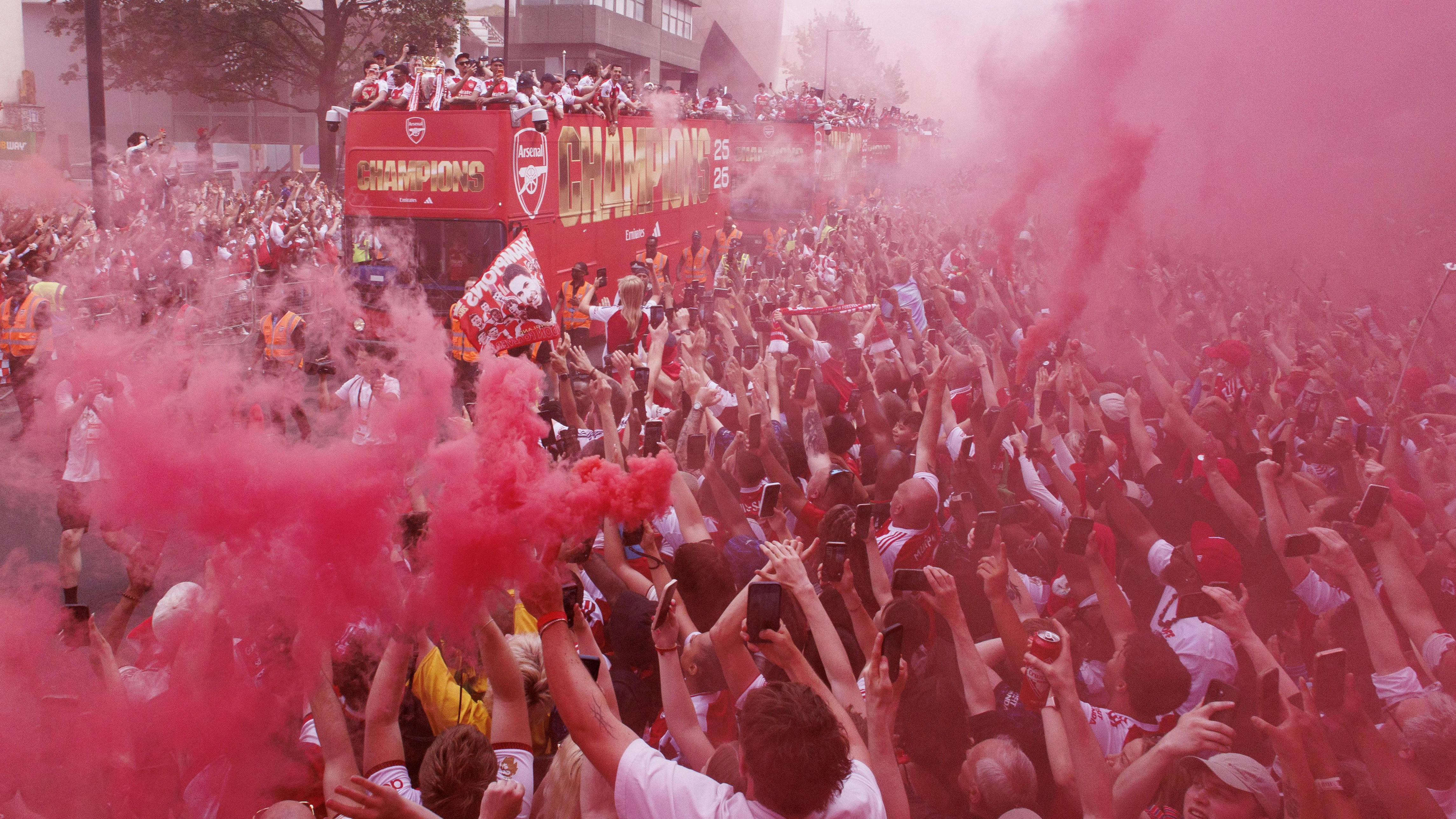Arsenal fans turn streets red for victory parade