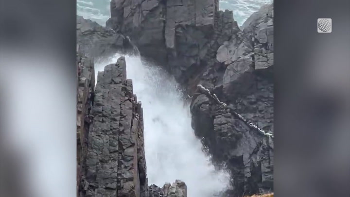 Powerful waves crash through Bonavista sea arch