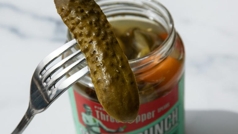 Use an empty pickle jar to create the perfect planter and drip tray combo