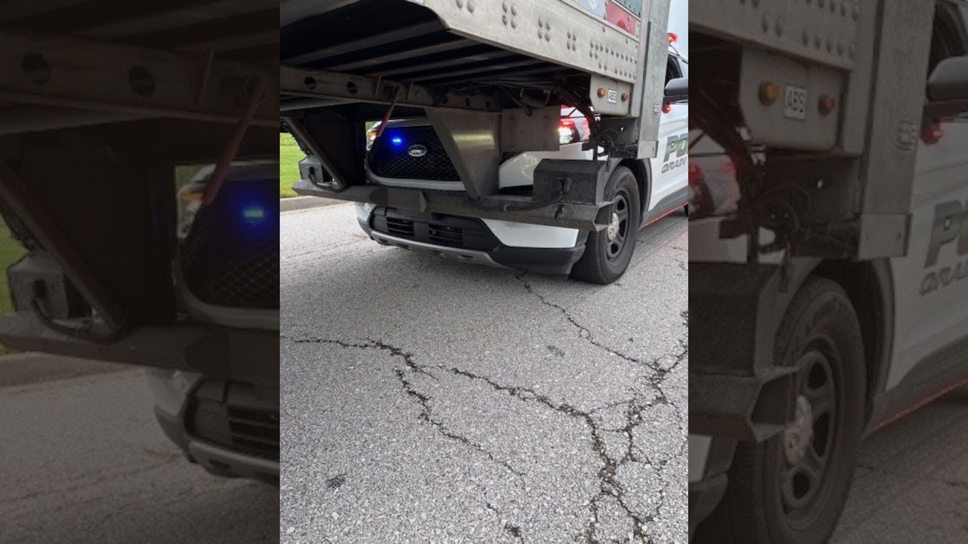 Grain Valley police officer okay after semi backs into patrol car