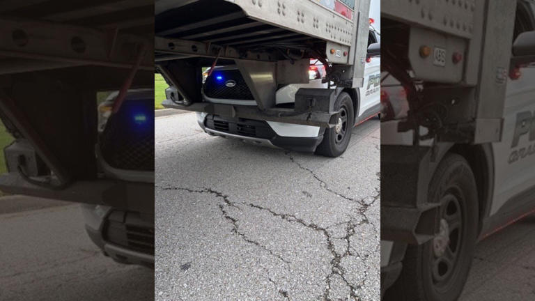Grain Valley police officer okay after semi backs into patrol car