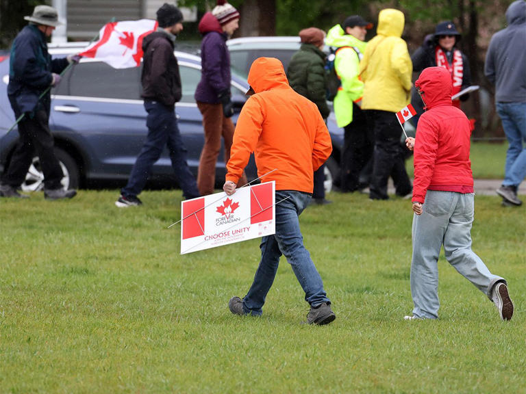 Hundreds of Calgarians brave pouring rain for Forever Canadian lawn ...