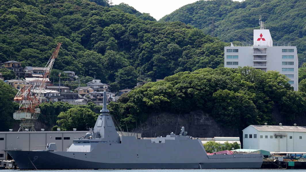 Japan rejects 'new militarism' label, warns over China's arms build-up