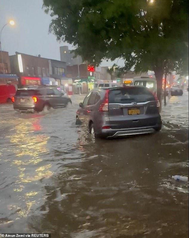 Moment off-duty firefighter breaks woman free from car submerged in flood