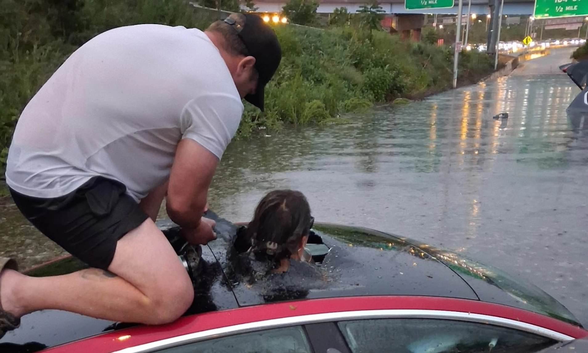Moment off-duty firefighter breaks woman free from car submerged in flood