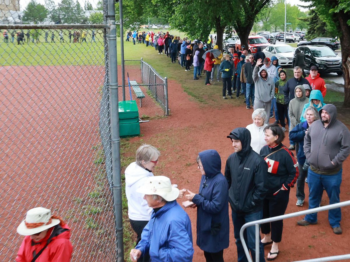 Hundreds of Calgarians brave pouring rain for Forever Canadian lawn ...