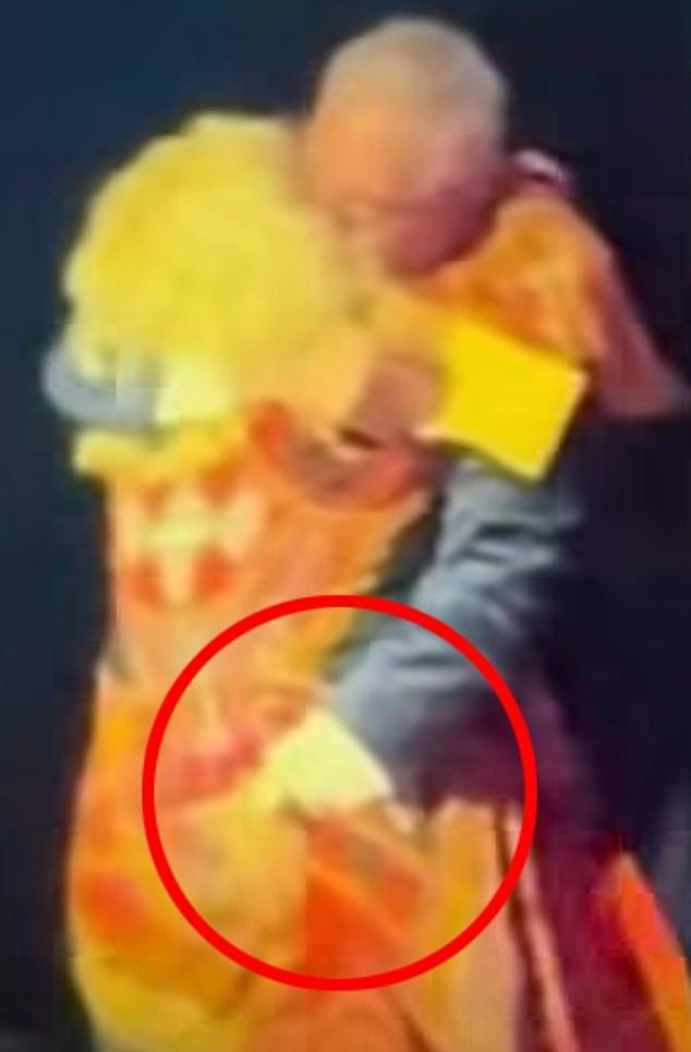 Crowd gasps as radio boss gropes presenter as she accepts award