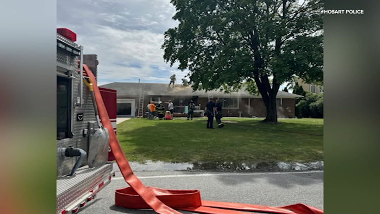Hobart police officer rescues family from house fire