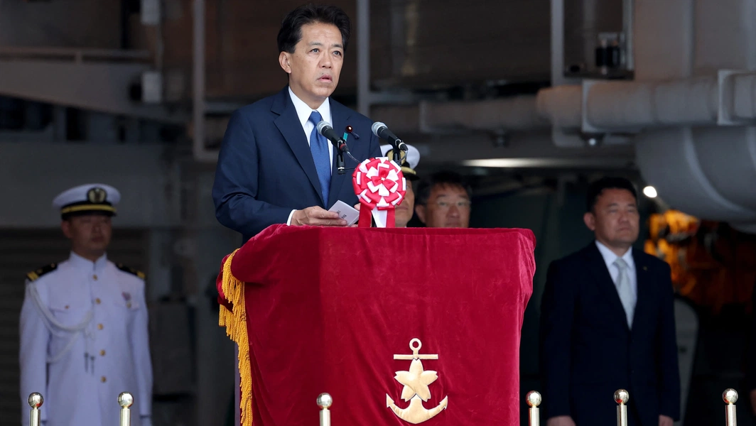 Japan rejects 'new militarism' label, warns over China's arms build-up