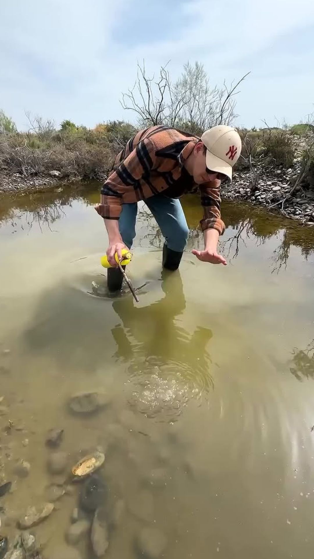 Exploring a swamp with natural gas bubbling to the surface