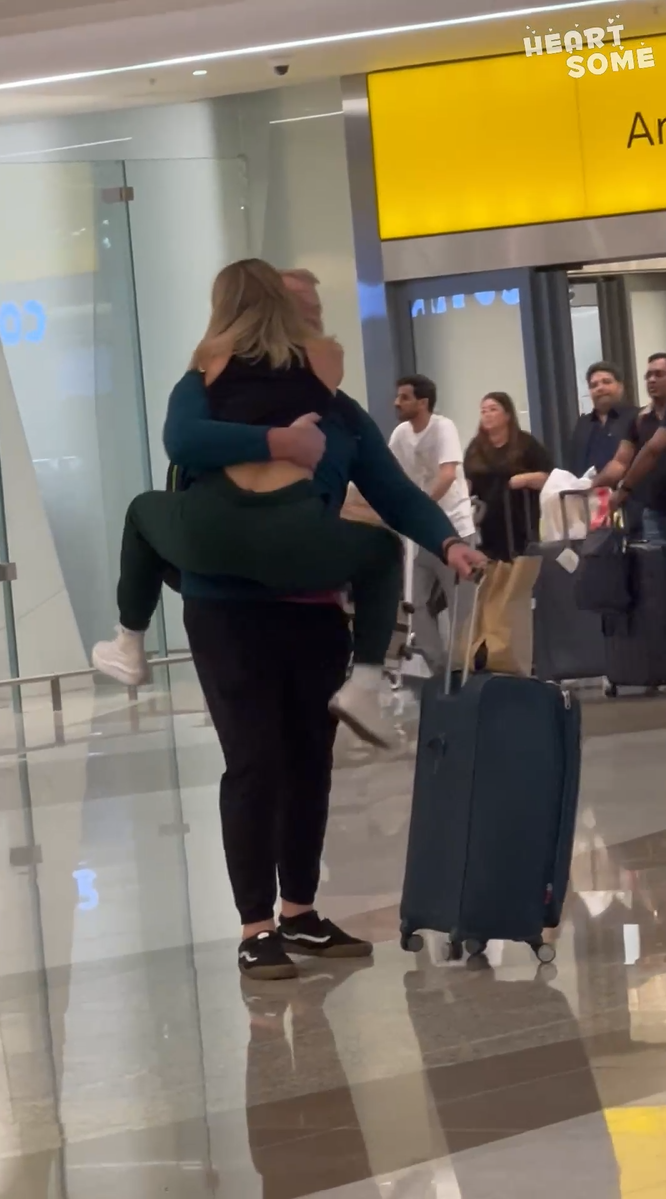 Long distance lovebirds heartwarming airport reunion