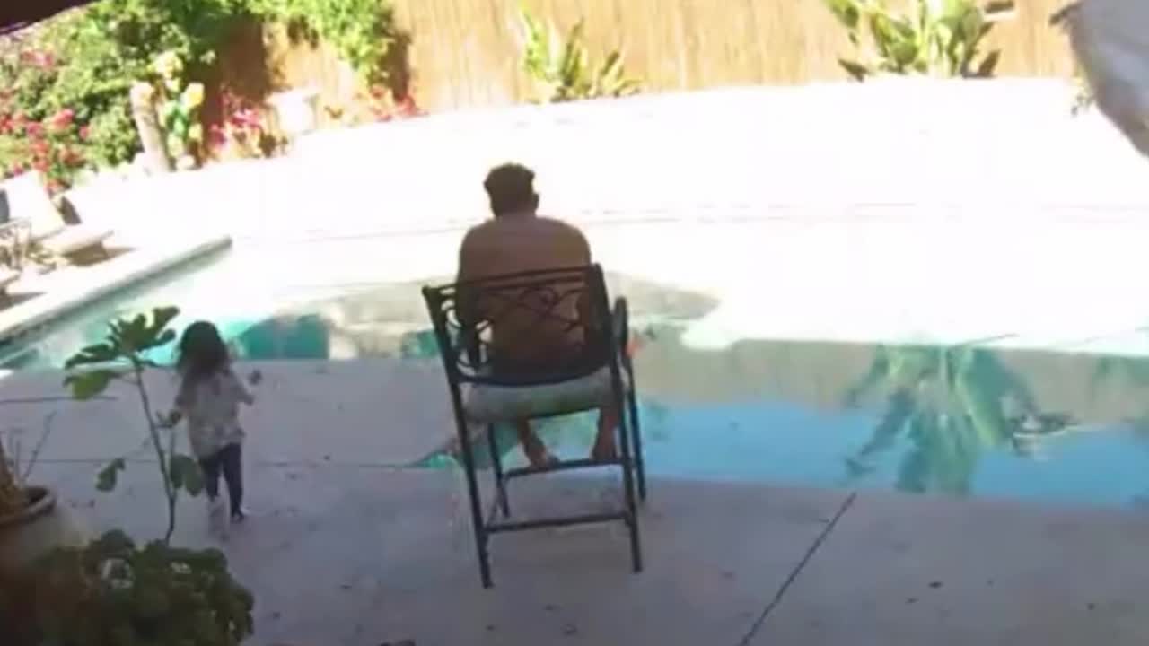 Quick-thinking father rescues daughter after she slips into swimming pool
