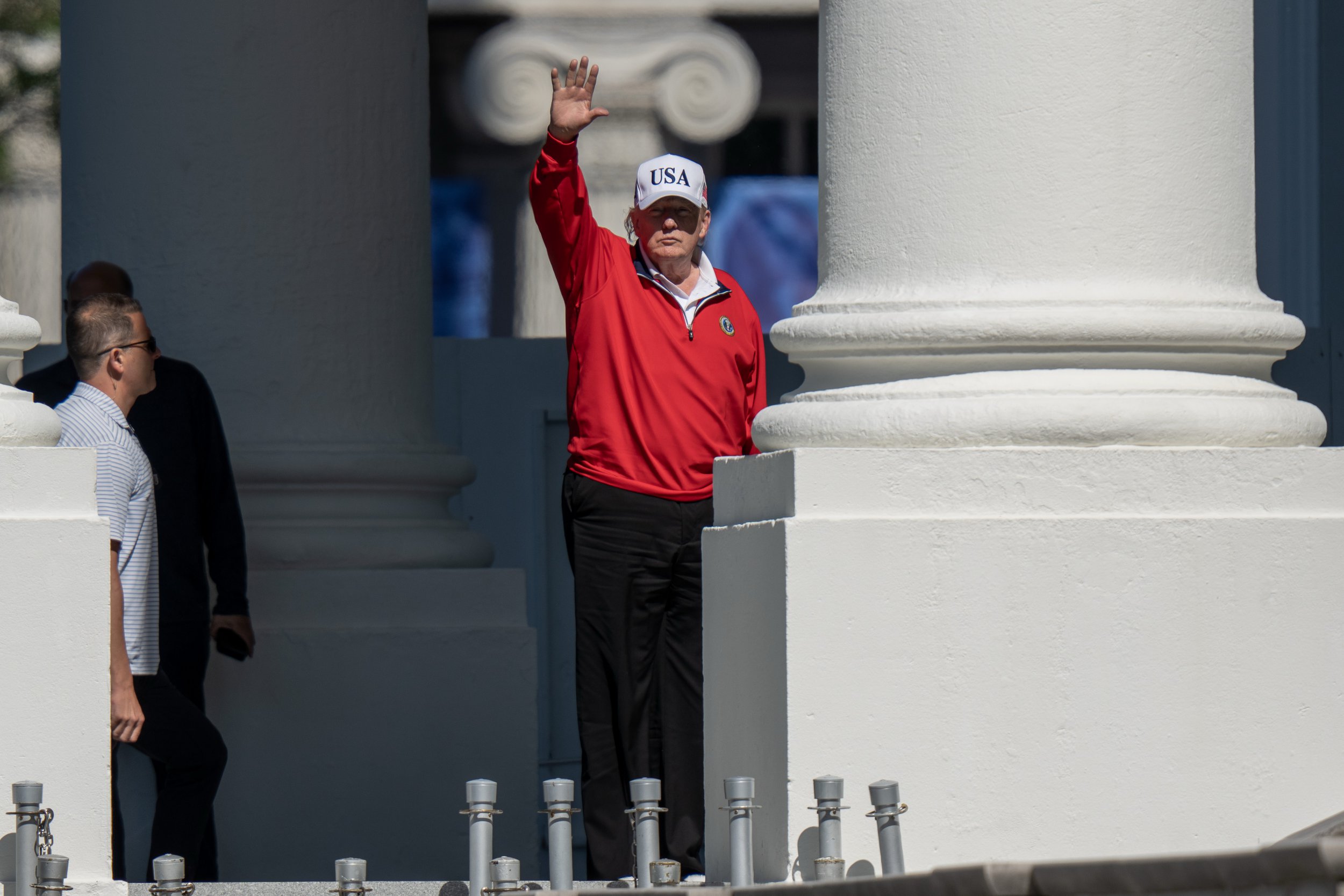 Donald Trump golfs with blonde aide and tells America to 'relax' about Iran