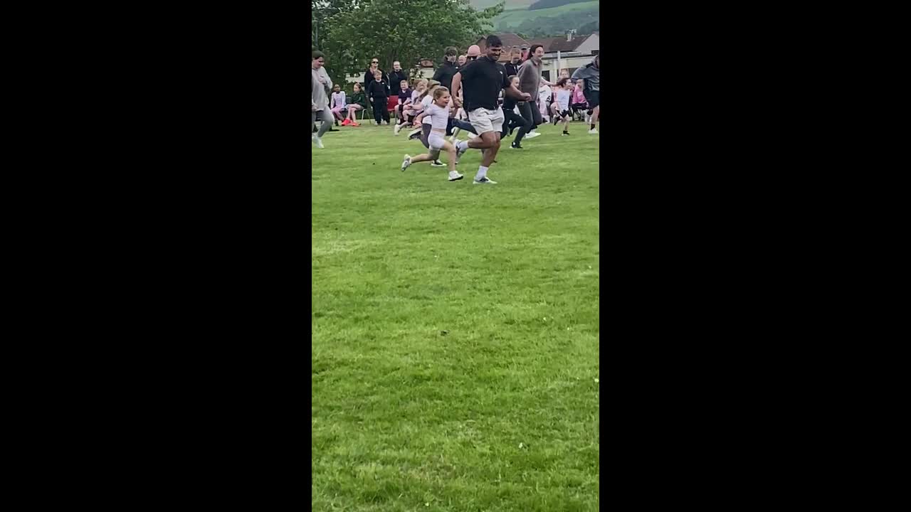 Determined dad drags daughter across finish line as parents take part ...