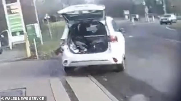 Moment handcuffed criminal speeds away from police with his car doors ...