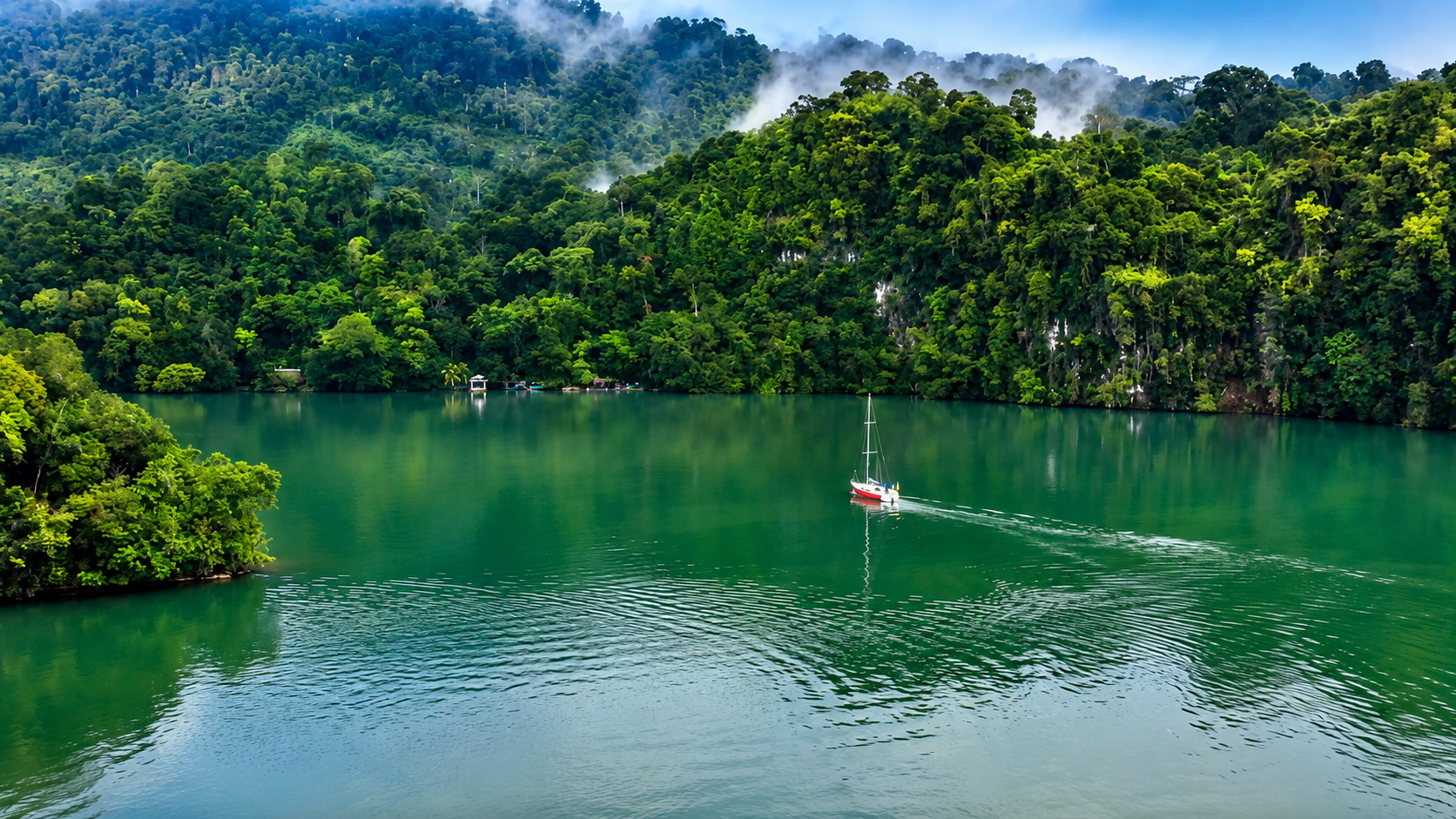 A jungle river winding through Rio Dulce’s green wilderness