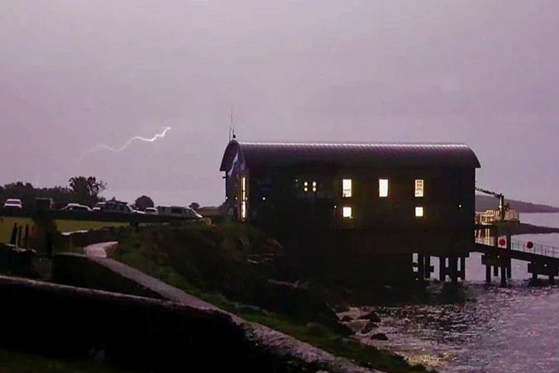 Watch as paddleboarder and dog rescued amid dramatic thunderstorm off ...