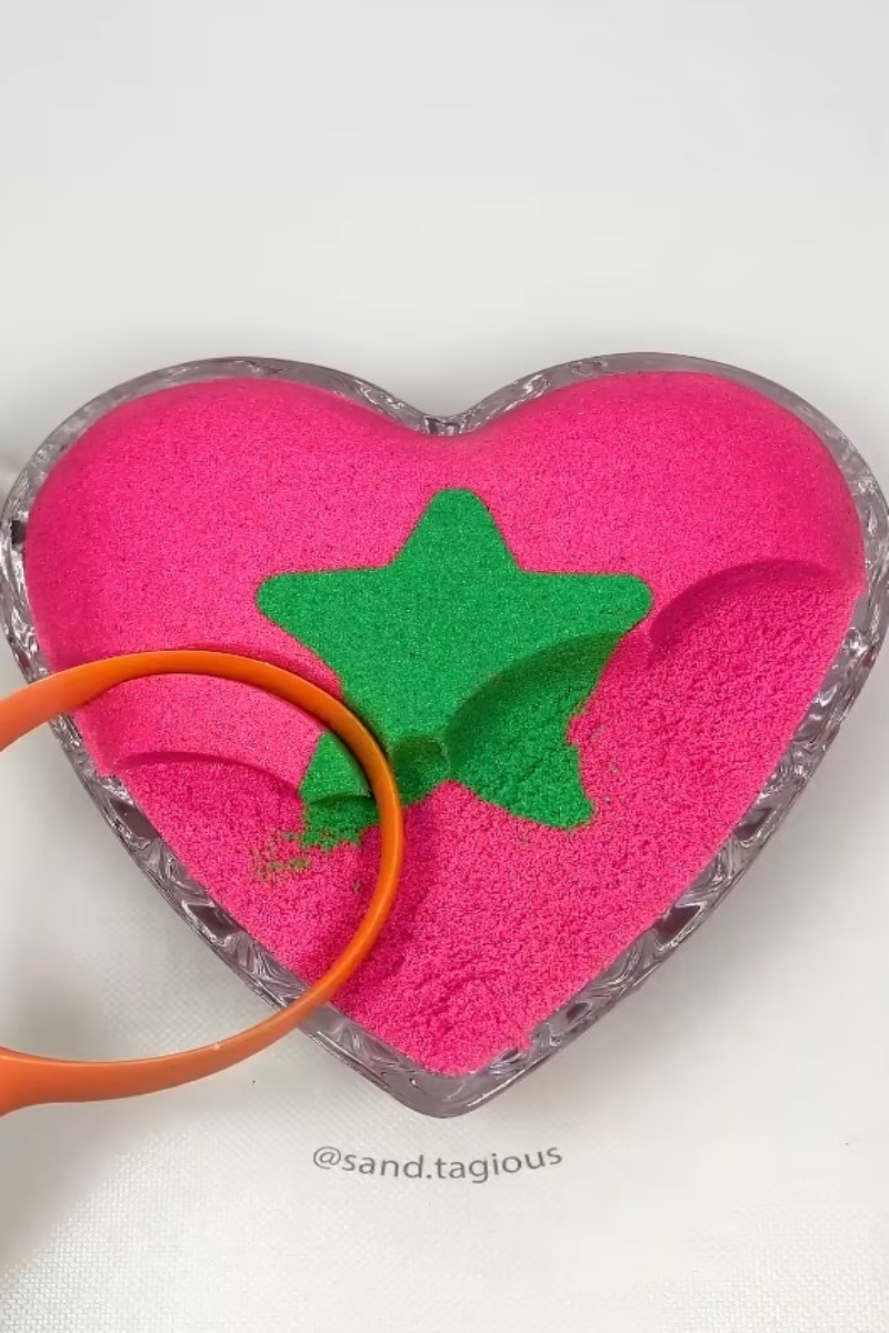 Vibrant heart-shaped sand art creation