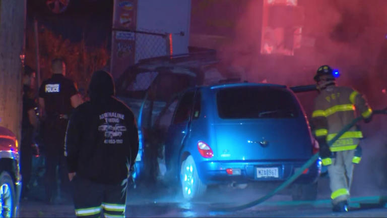 Car crashes into parked vehicles, catches fire at used auto sales lot ...