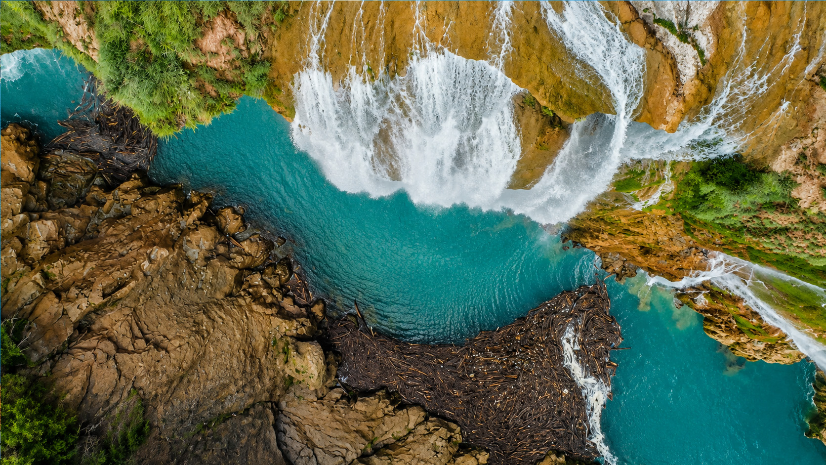 Tamul waterfall dropping into turquoise waters in Mexico