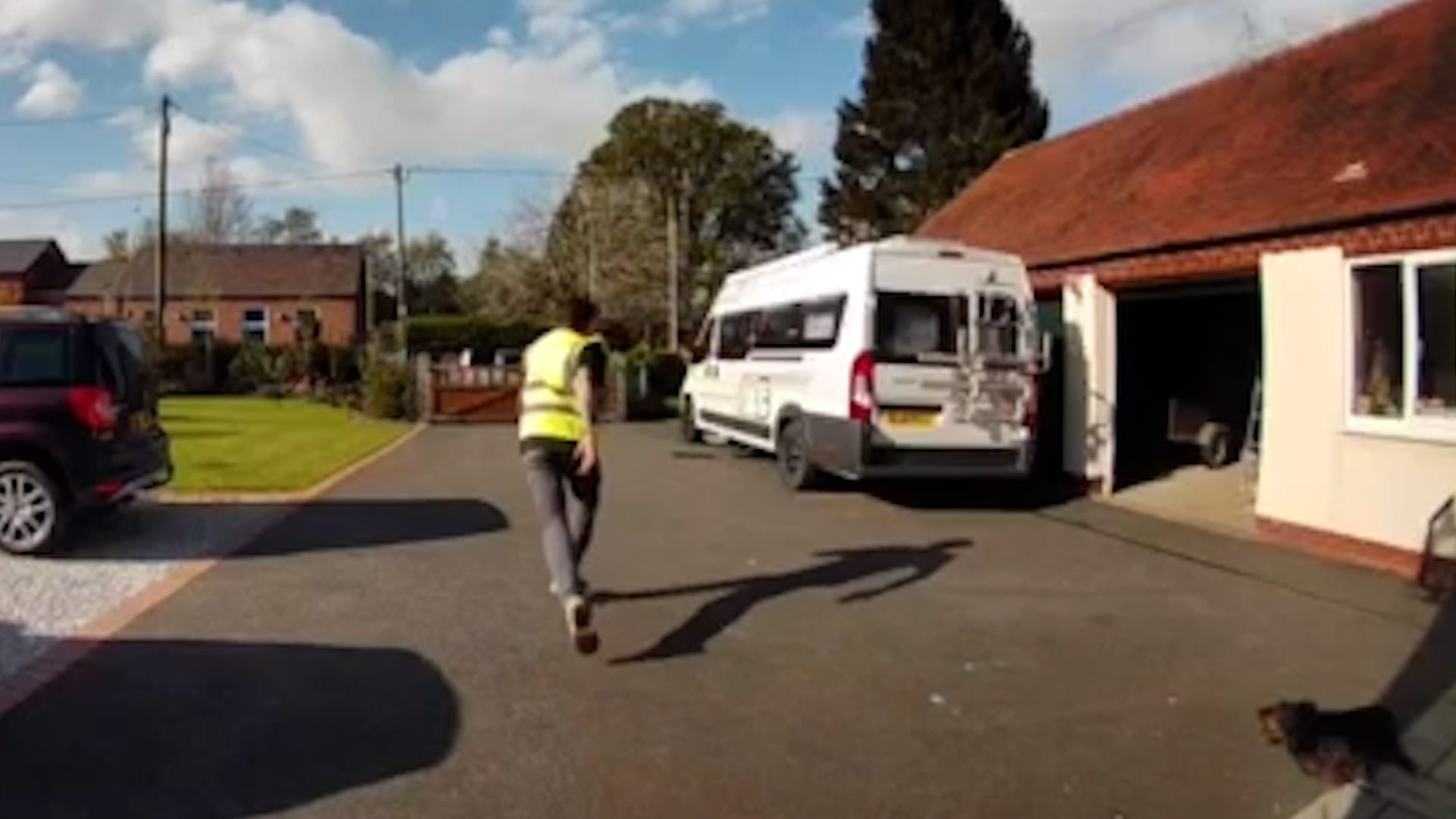 Delivery man sprints and leaps over gate after being chased by tiny pet dog
