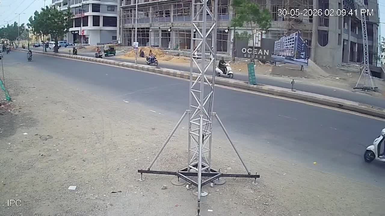 Motorcycle riders narrowly avoid gantry billboard as it crashes onto road