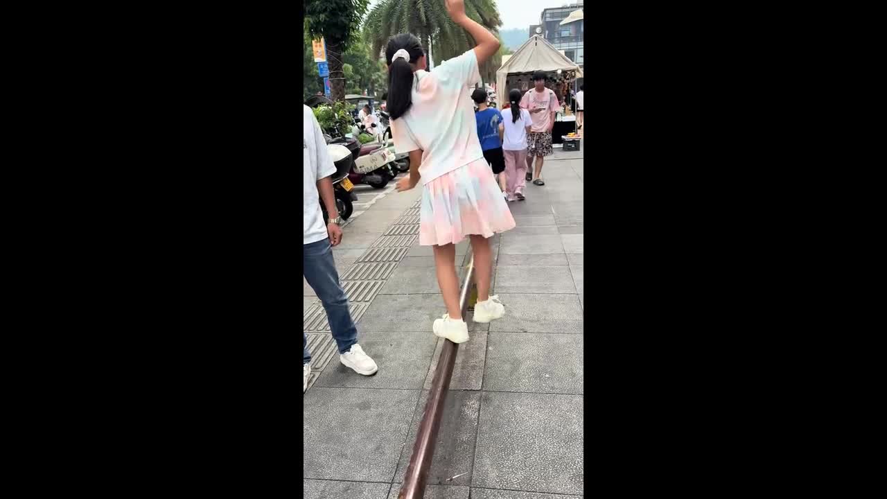 Child falls after stepping on rail after another child kicks metal bar ...