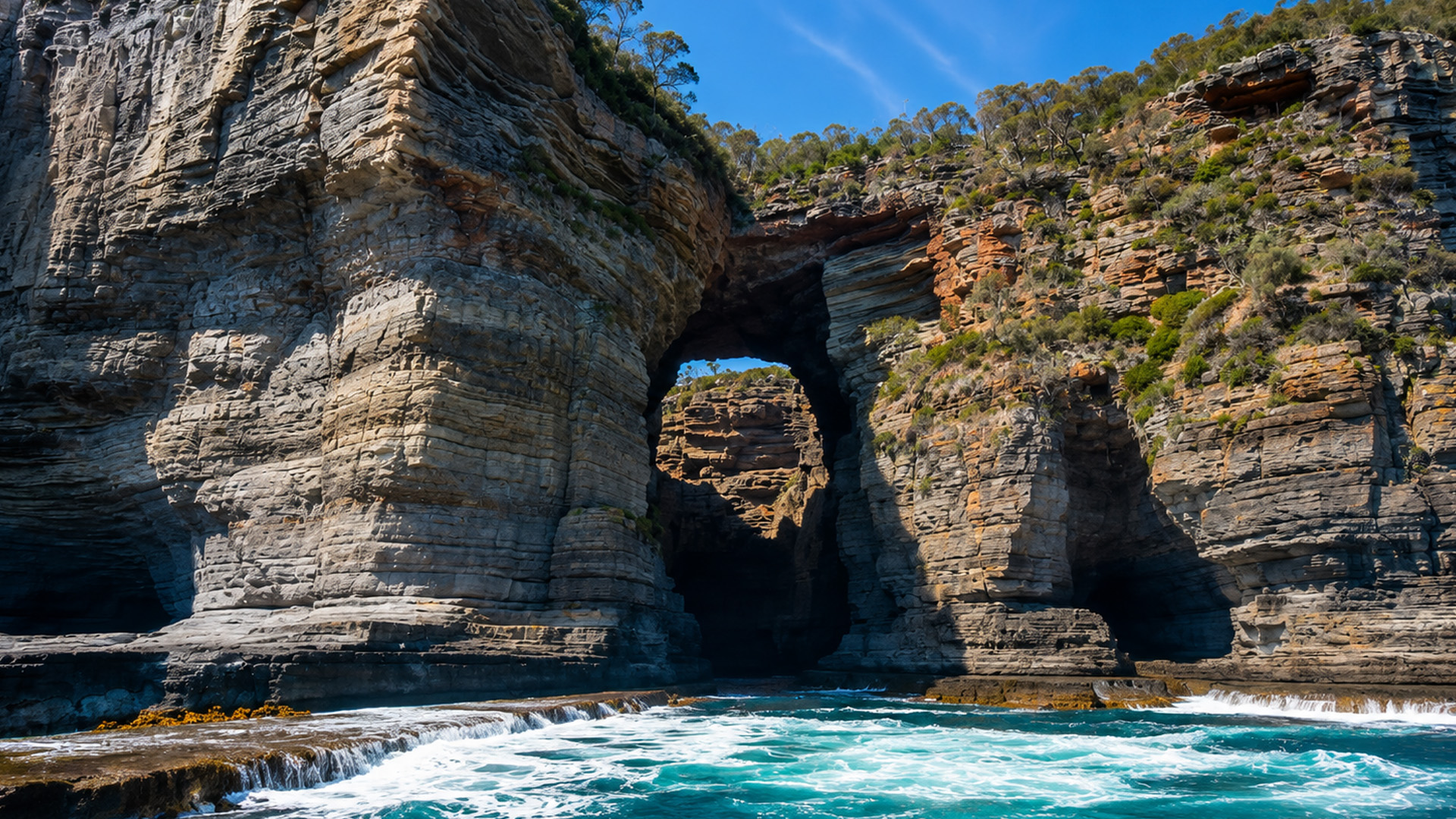 Waves carved a door through these cliffs