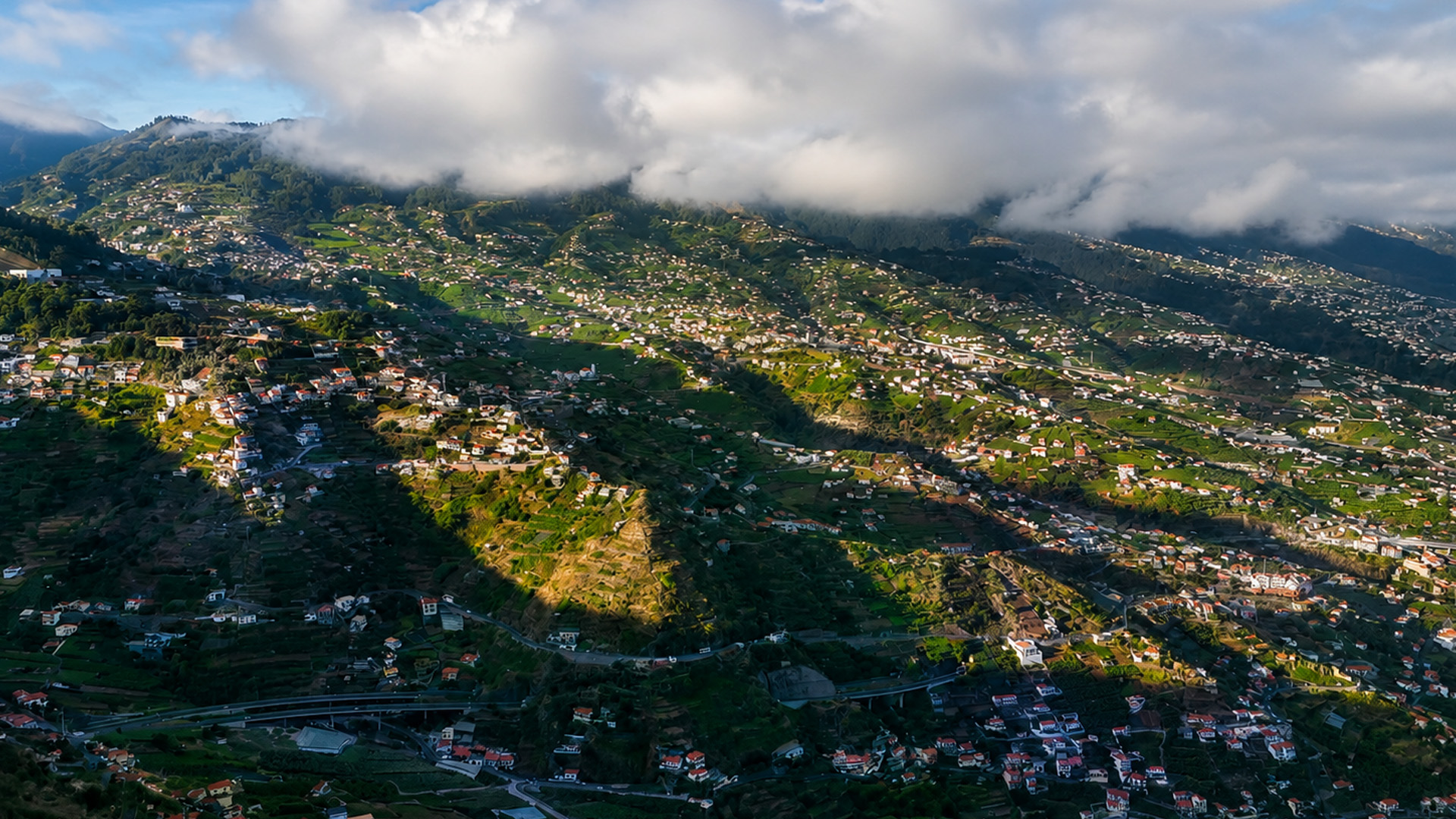 Why are homes scattered across these steep hills?