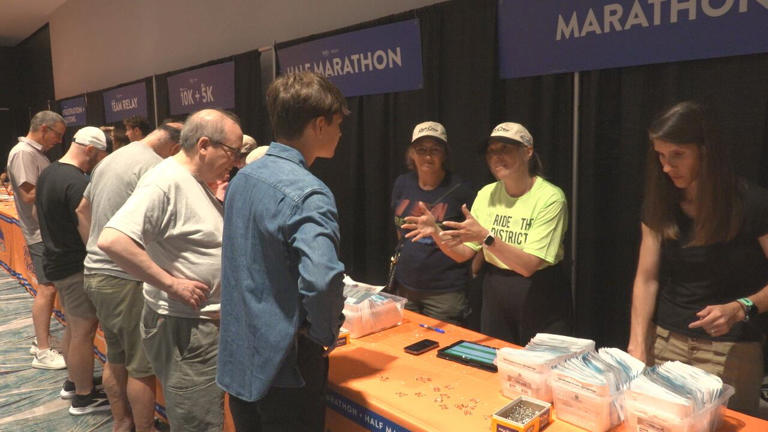 Runners pick up bibs at expo ahead of Cedar Rapids Marathon