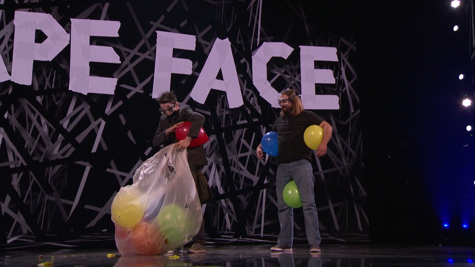Tape Face: Strange mime plays staple gun quick draw with balloons ...