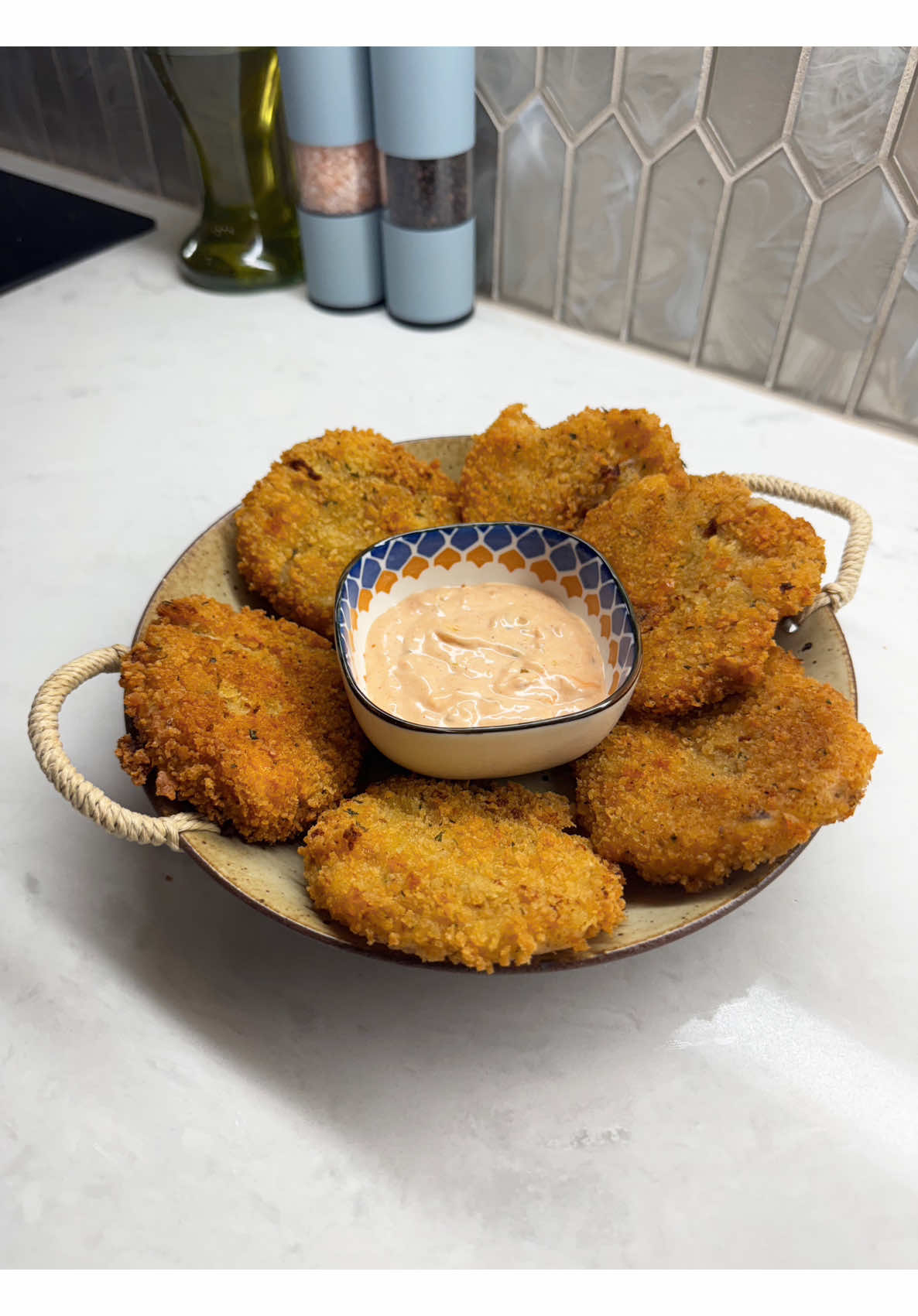 Eating crispy golden fried fritters with a creamy dipping sauce on a ...