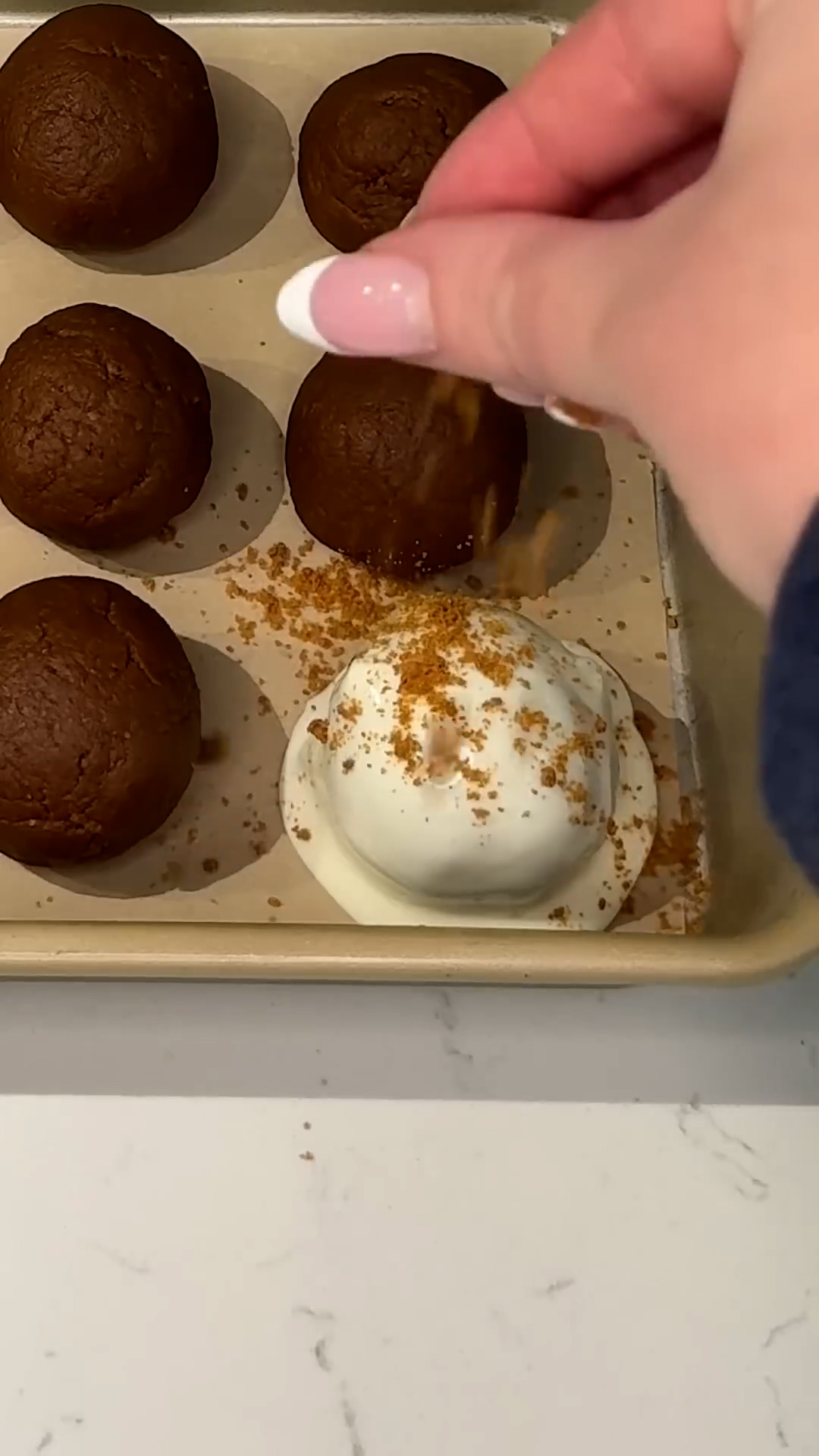 Crushed spiced cookies mixed with frosting and shaped onto sticks