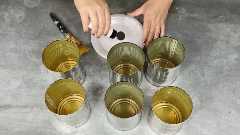 Turn empty soup cans into a handy garden tool caddy for easy storage