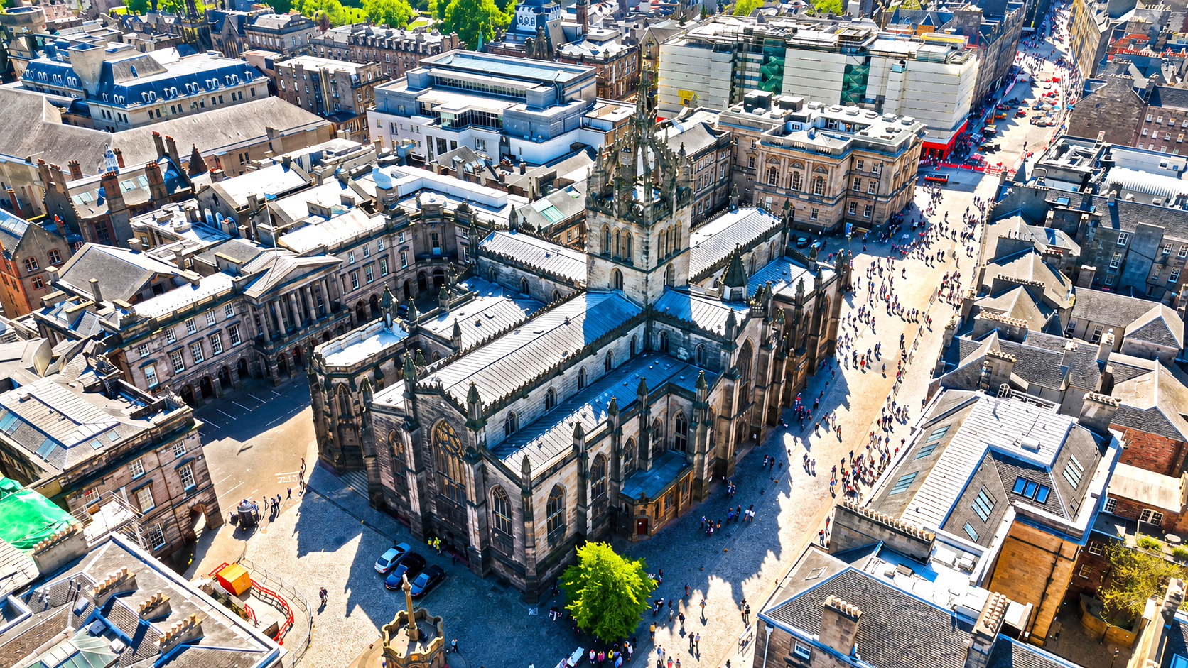 A towering historic cathedral rising above a lively city square