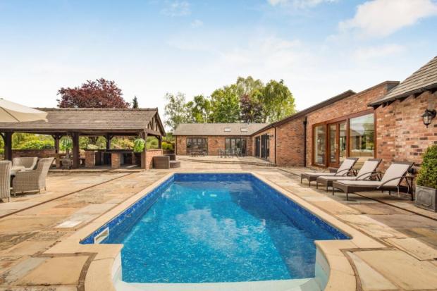 Home with helipad, driving range and spa for sale in Warrington for ...