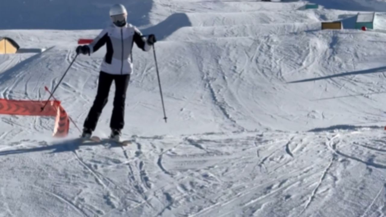 Skier tries a jump but slides after hard landing on snow