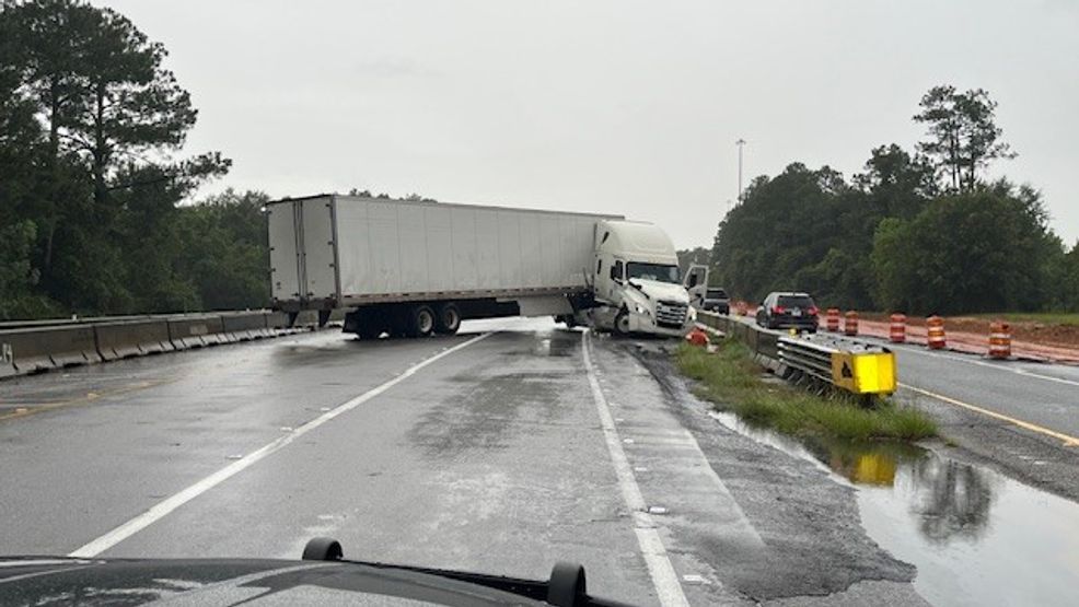 Semi truck hydroplanes, hits concrete barrier on I-10 in Escambia County