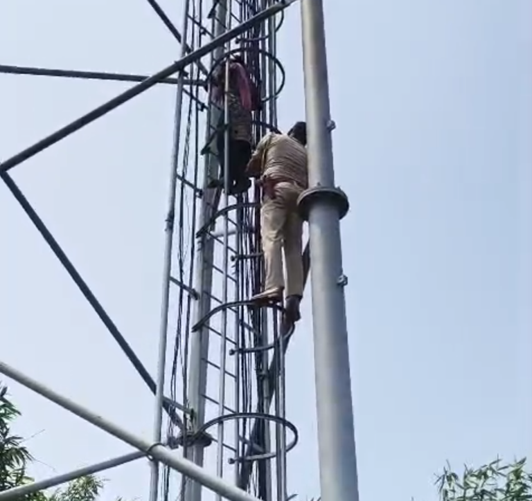 Woman climbs mobile tower, rescued