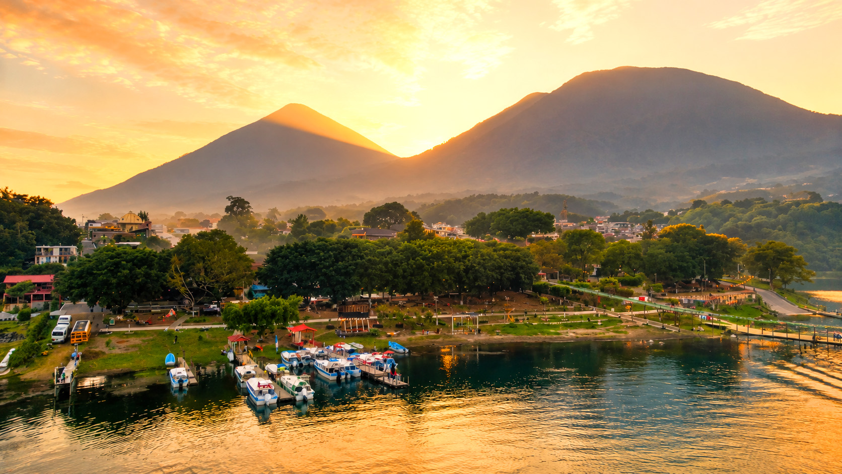 A quiet Lake Atitlán village glowing beneath volcanic peaks