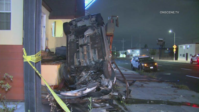 Car crashes into Wilmington home, ends up standing vertically on porch