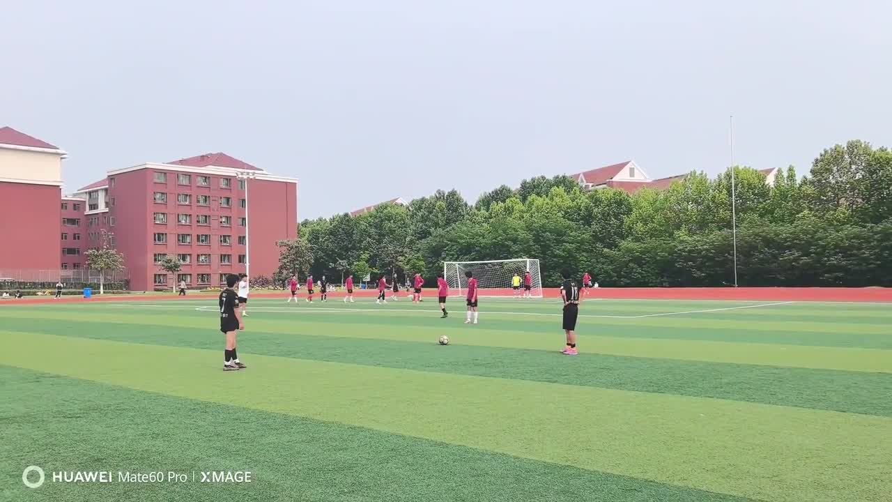 Player scores from set piece during football match in Jiangsu, China
