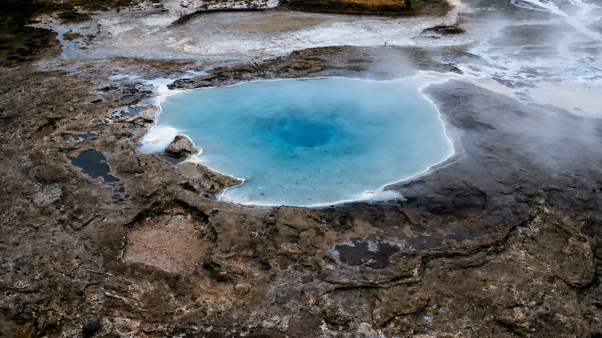 Why is this blue pool boiling underground?