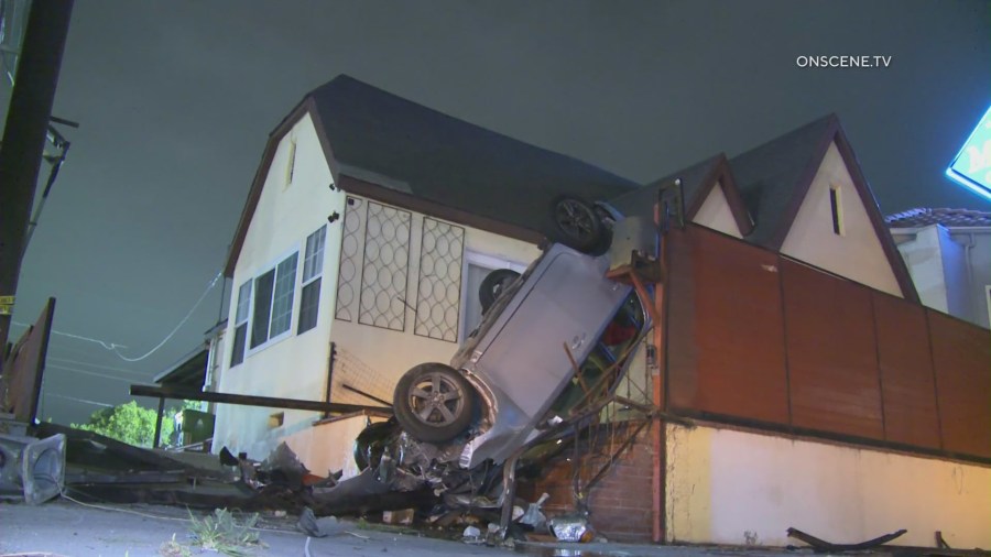Car crashes into Wilmington home, ends up standing vertically on porch