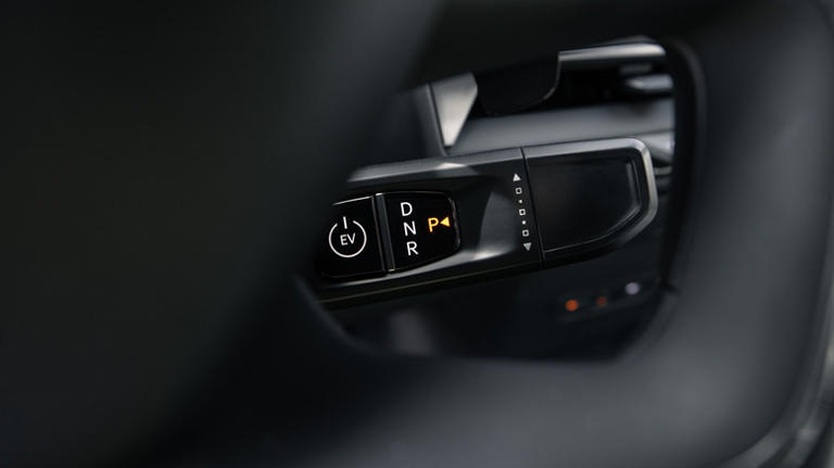 Why did most car manufacturers stop using column-mounted gear shifters?