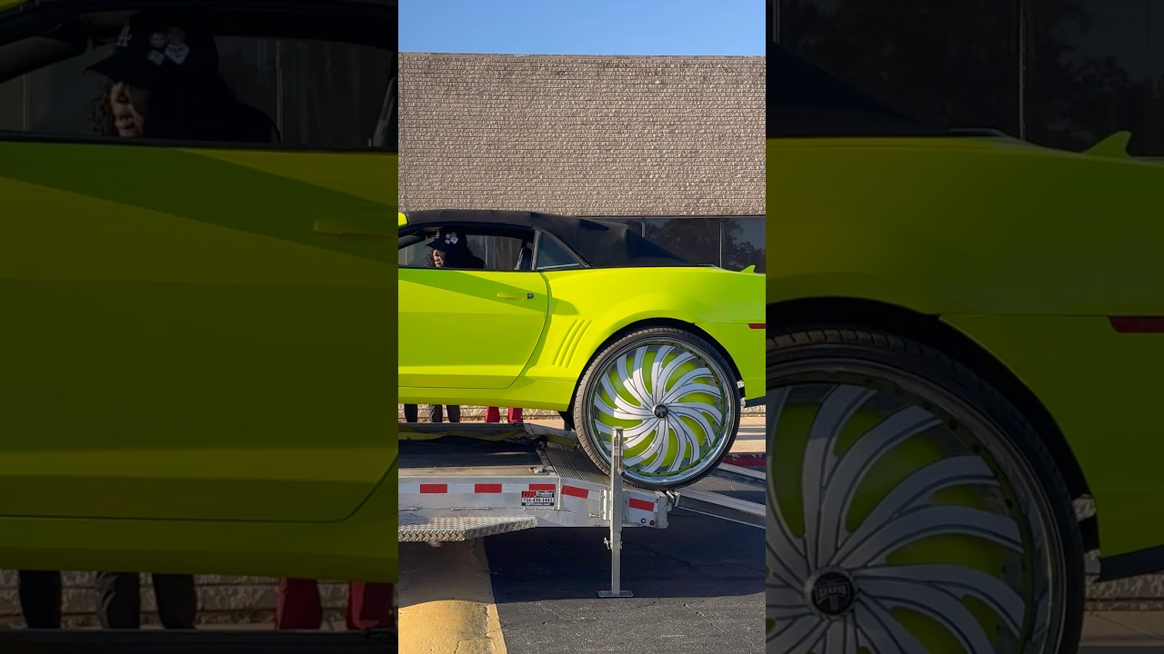 Chevy Camaro vert on 32’s DUB floaters coming off transport